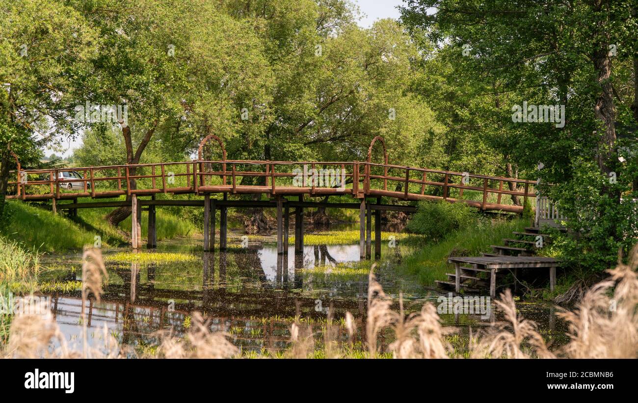 wooden high bridge over an overgrown river bed Stock Photo - Alamy