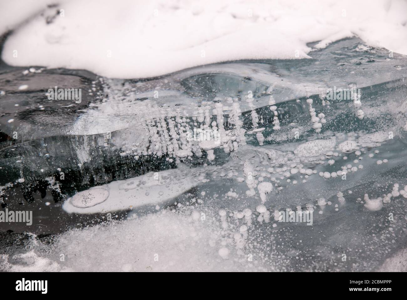 Bubbles of methane gaz frozen into clear ice on Lake Baikal, Russia ...