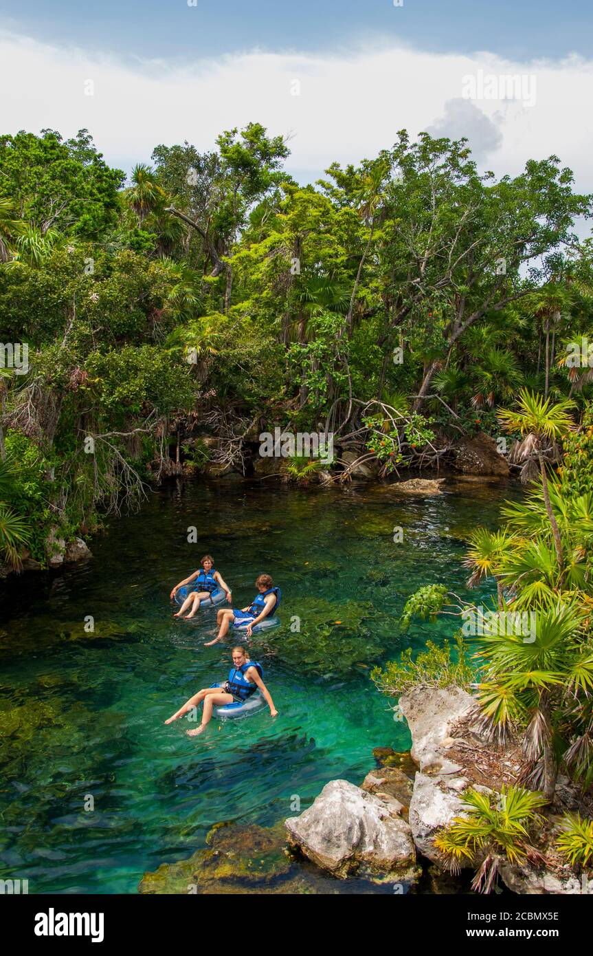 People (model released) floating down a small river in inner tubes at ...