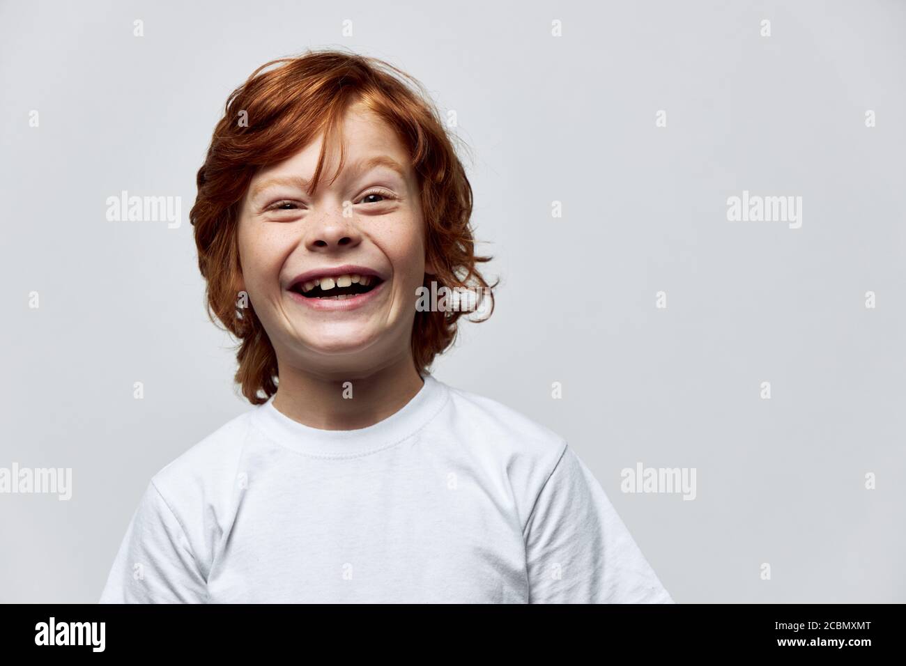 ginger child wide smile cropped view white t-shirt studio Stock Photo ...