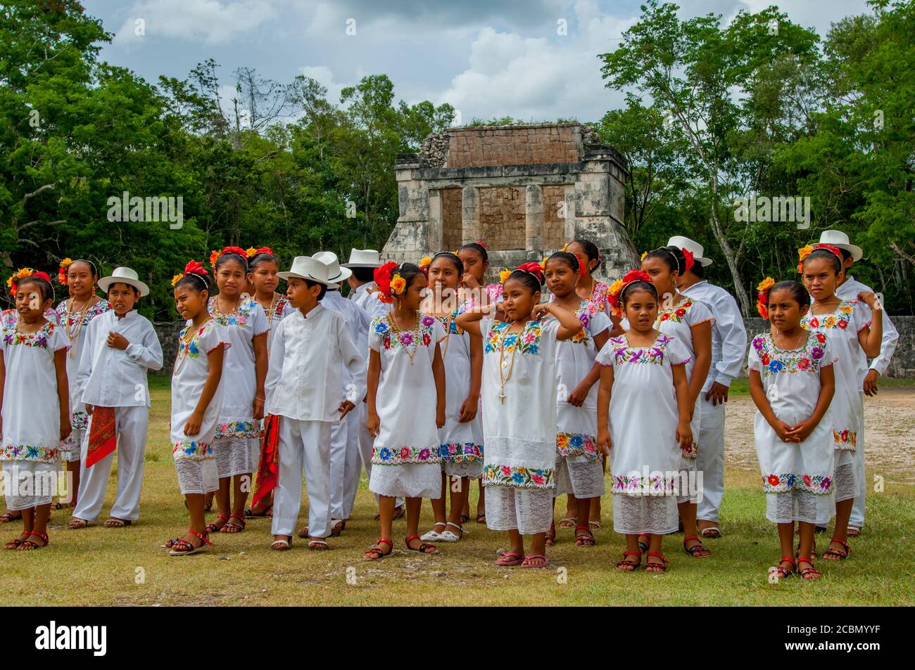 A group of Mayan children (dance group) visiting the great ball court ...