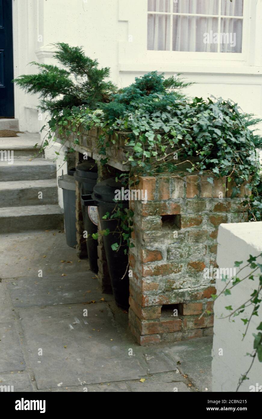 Top of purpose built dustpin store planted with evergreen plants Stock ...