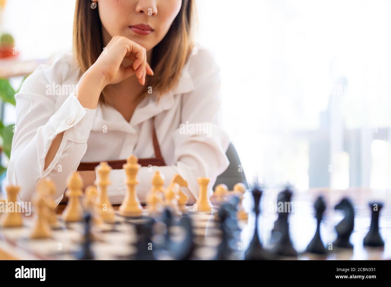 Beautiful woman playing chess hi-res stock photography and images - Alamy