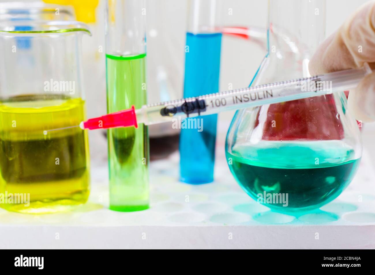 Insulin needle and portion, doctors hand with glove and lab situation ...