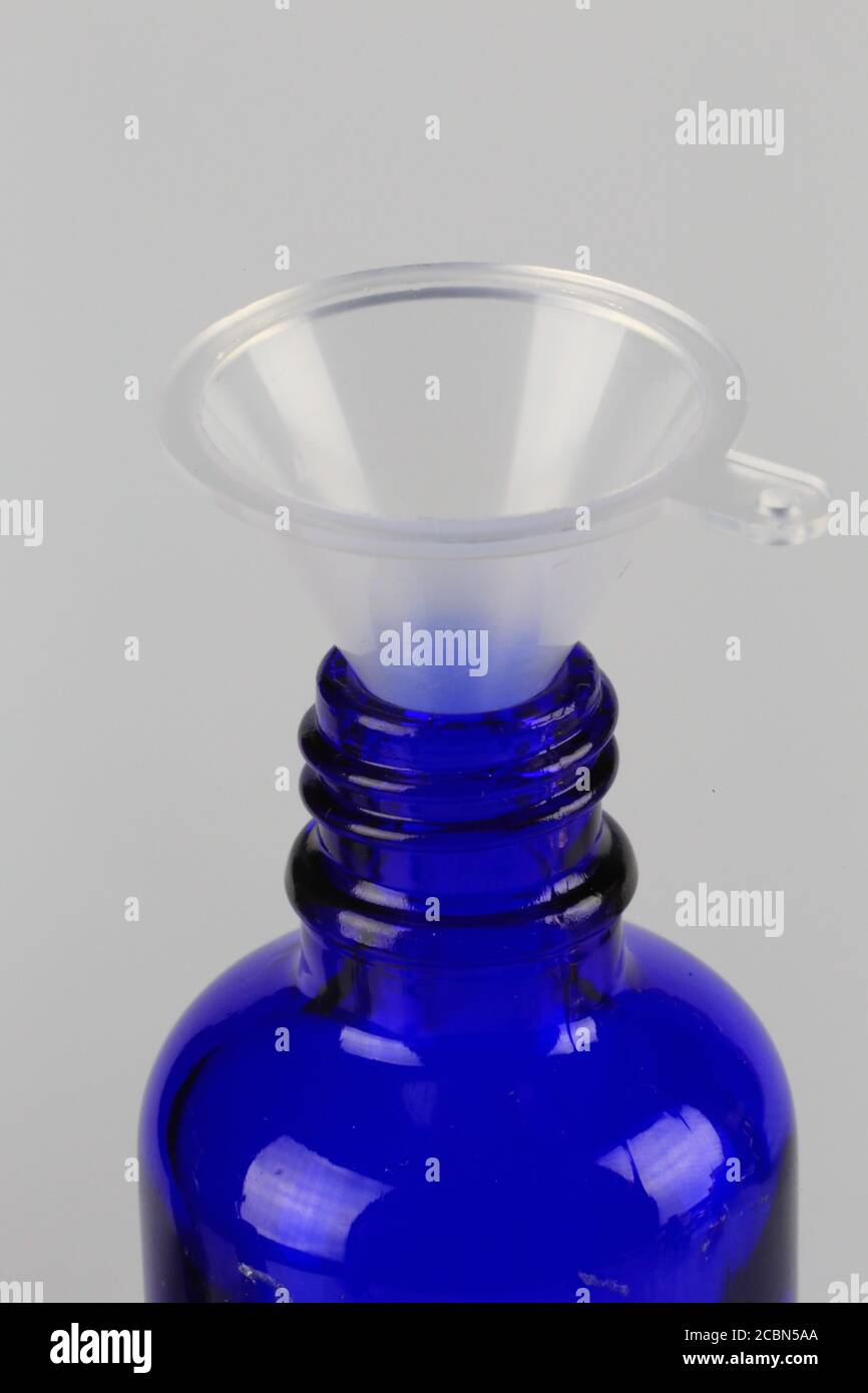 Essential Oil health bottle and filling funnel Stock Photo - Alamy