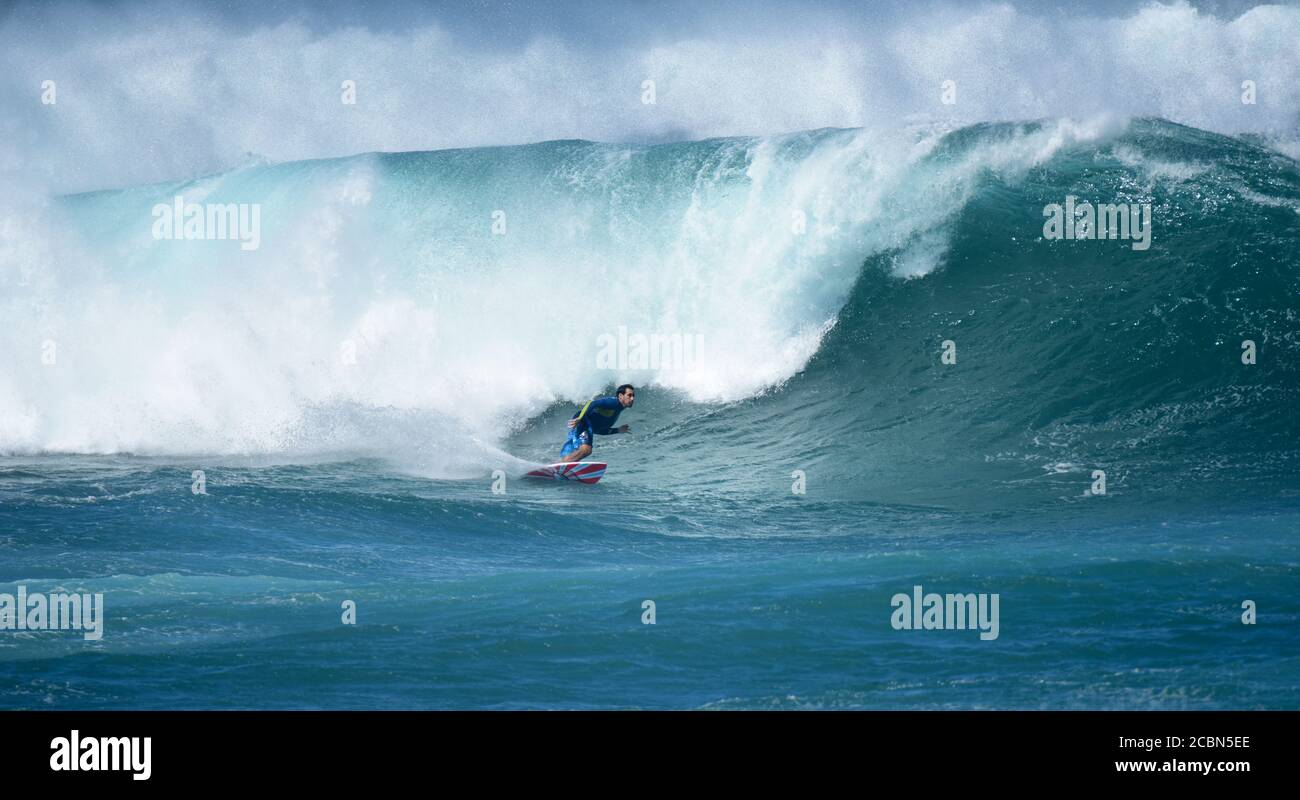 Surfer catches a massive wave in one of the first winter swells. Maui ...