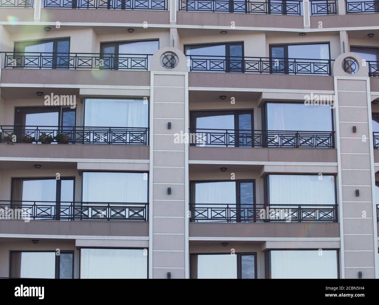 High hotel building with balconies with metal fences Stock Photo - Alamy
