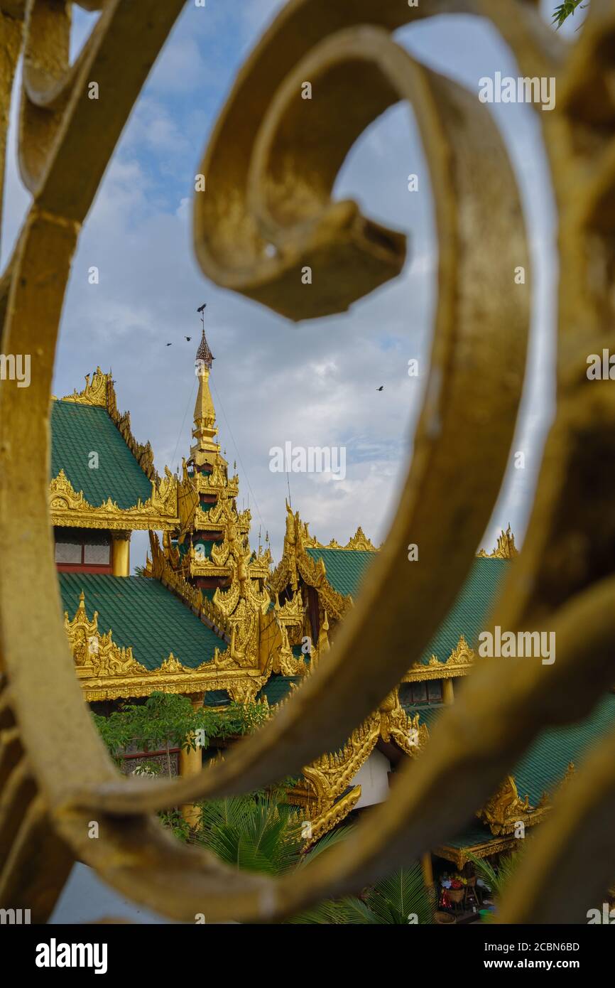 Yangon, Myanmar, Shwedagon Pagoda temple complex through a railing ...
