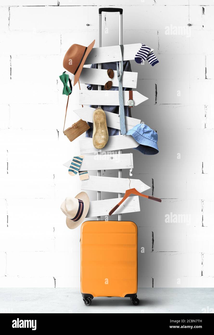 Travel suitcase with wooden signs and hanging clothes and accessories ...
