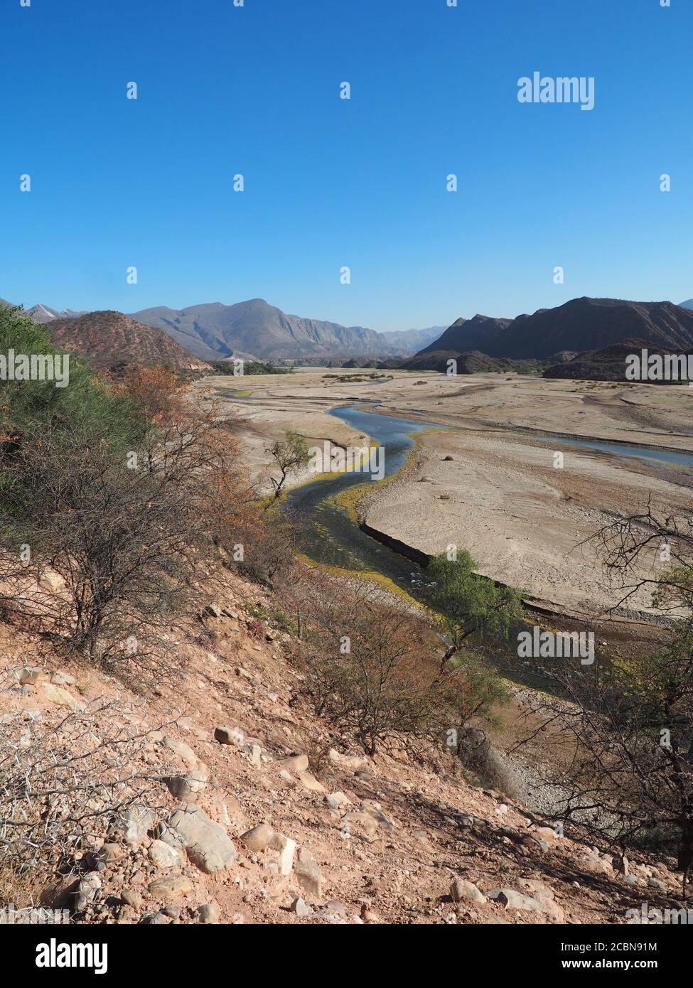 Mesmerizing view of a natural landscape with a narrow river and hills ...