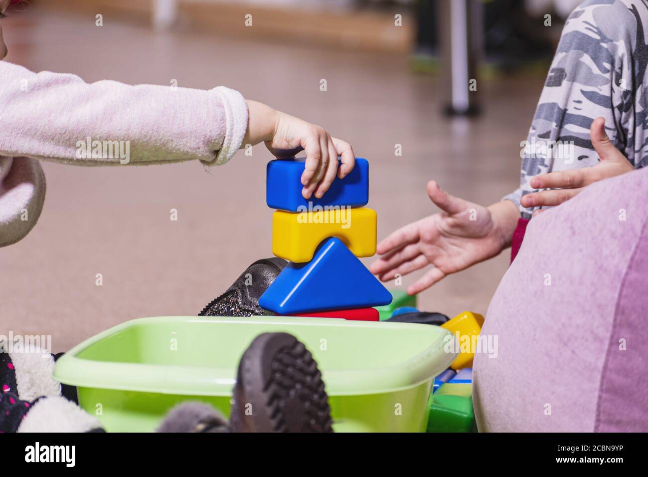 Children's hands and multi-colored plastic objects Stock Photo - Alamy