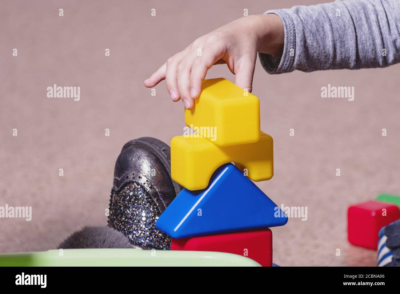 Children's hands and multi-colored plastic objects Stock Photo - Alamy