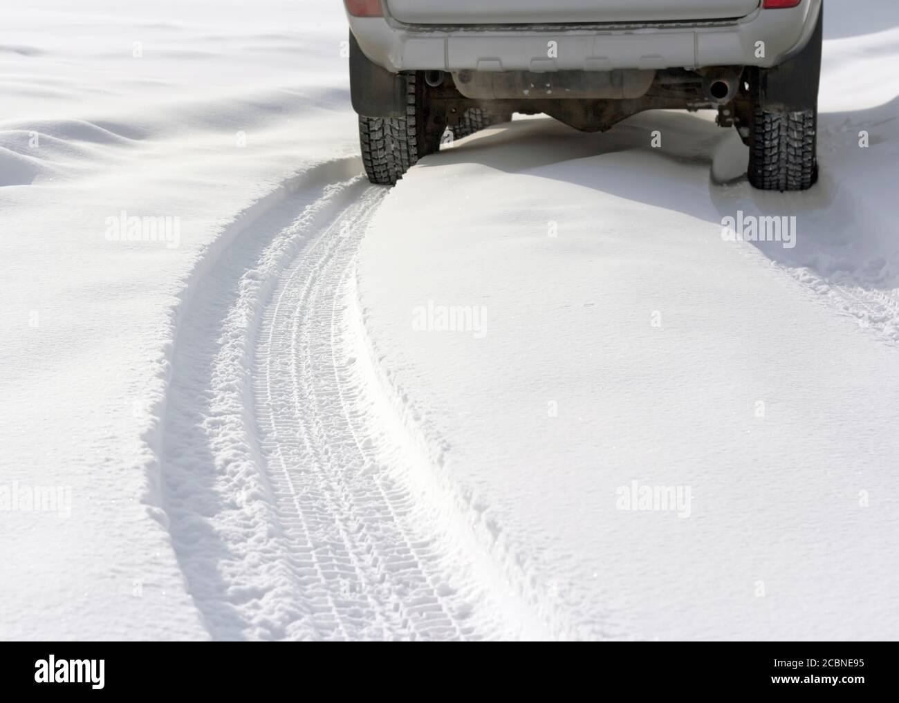 Snowy winter road behind an unrecognizable car Stock Photo - Alamy