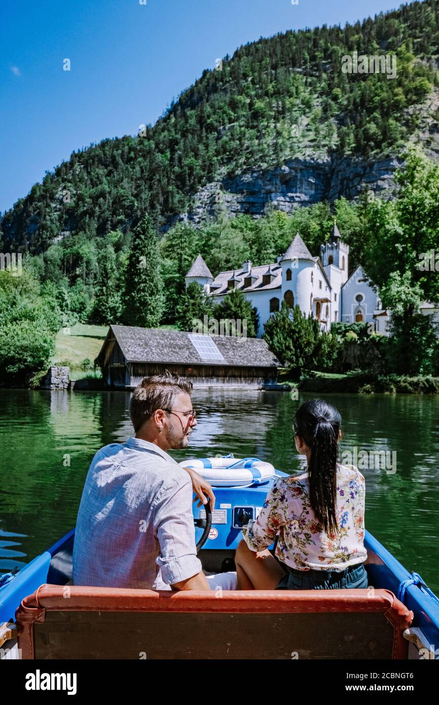 couple visit Hallstatt village on Hallstatter lake in Austrian Alps ...