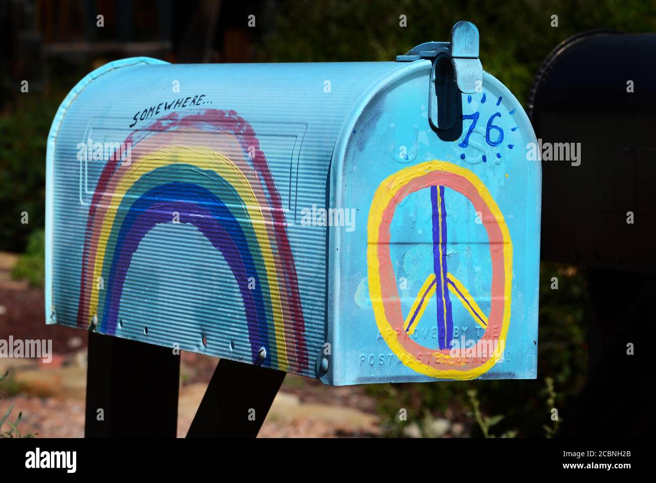 A mailbox decorated with a painted rainbow and peace symbol Stock Photo ...
