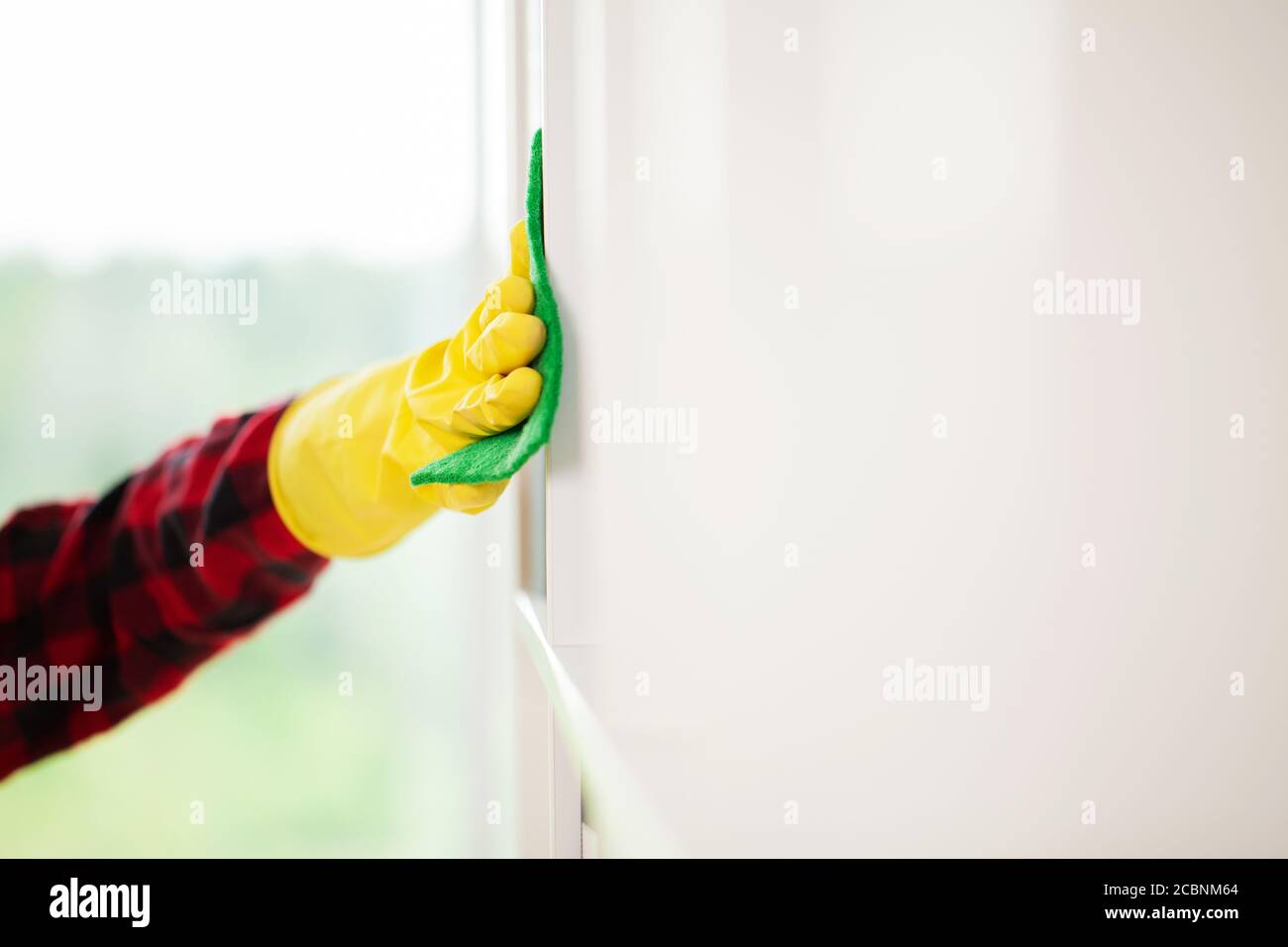 The cleaning lady does the cleaning in the office with a wet cloth ...