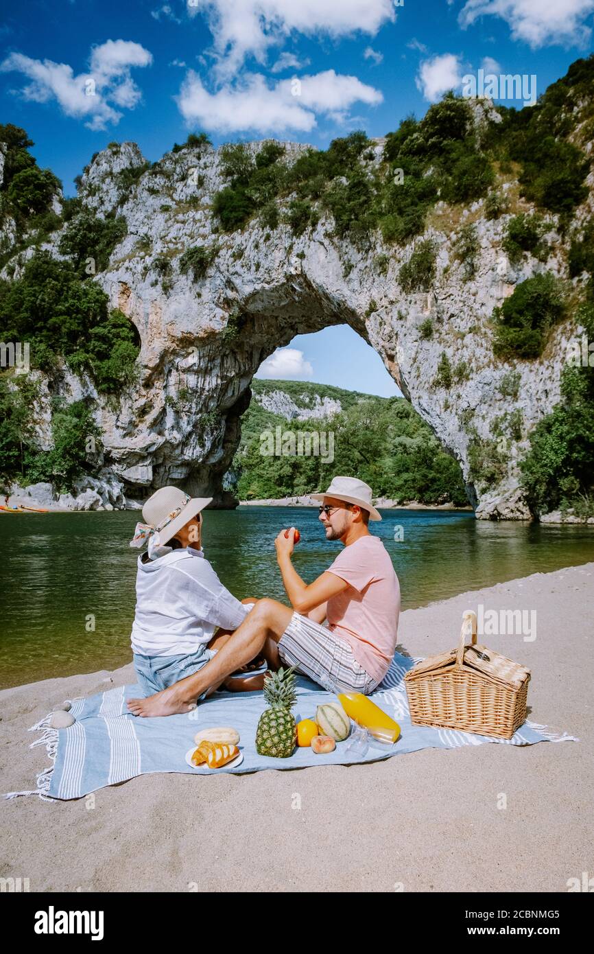 couple on the beach by the river in the Ardeche France Pont d Arc ...