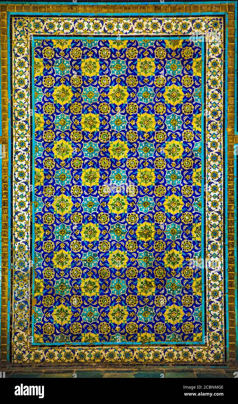 Vertical shot of a ceramic wall texture with painted colorful patterns ...