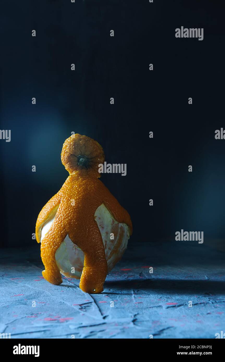 human figure from orange peel carries away peeled orange Stock Photo ...