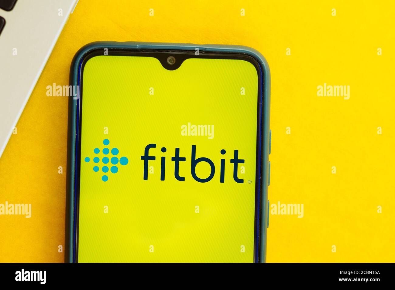 In this photo illustration the Fitbit logo seen displayed on a ...