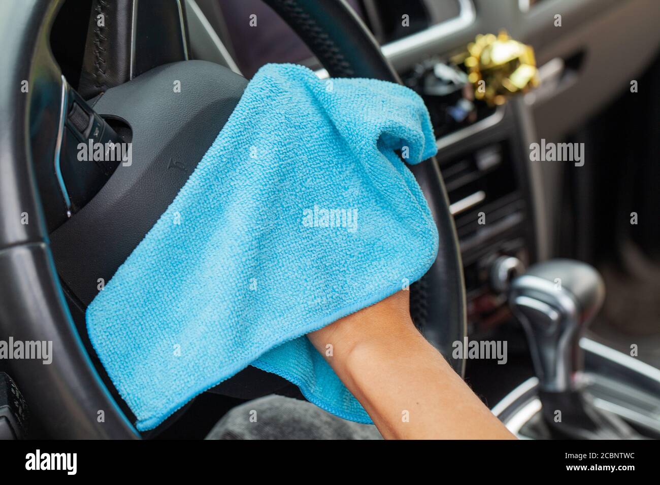 Close up of woman wiping car interior with blue rag Stock Photo - Alamy