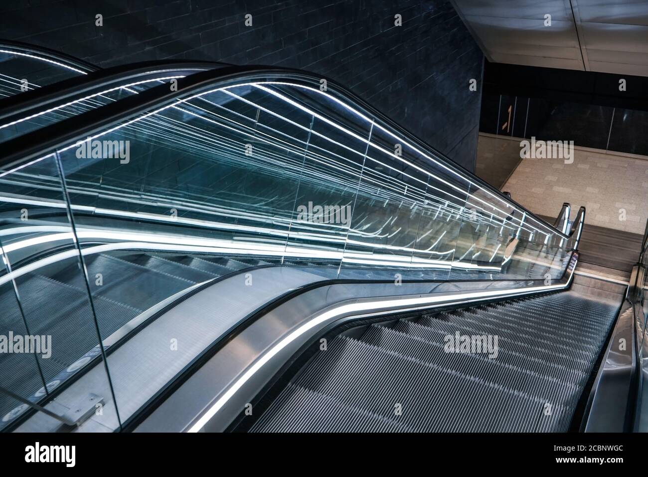 Looking down futuristic escalator moving stairs in modern offices Stock ...