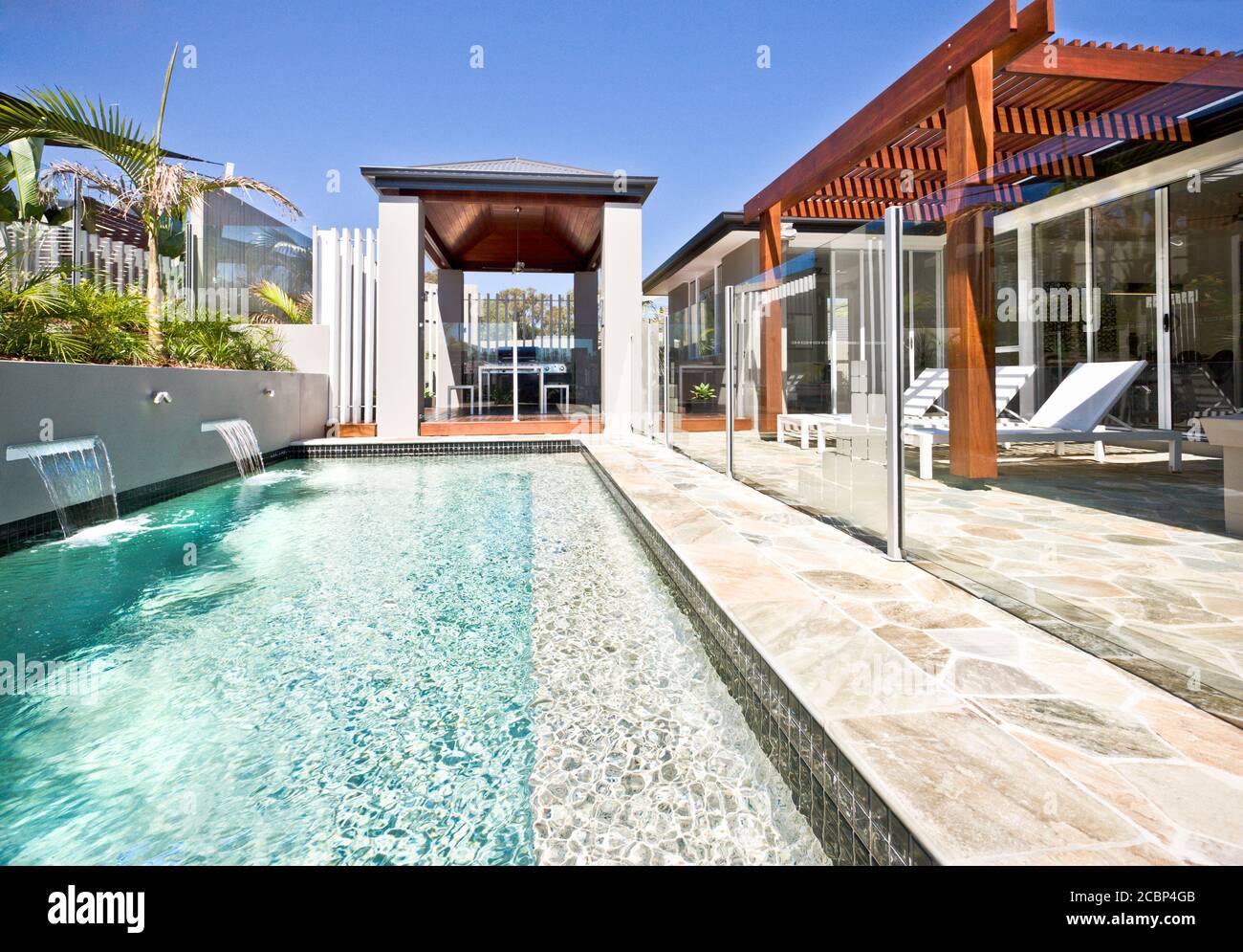 A large swimming backyard pool in modern house Stock Photo - Alamy