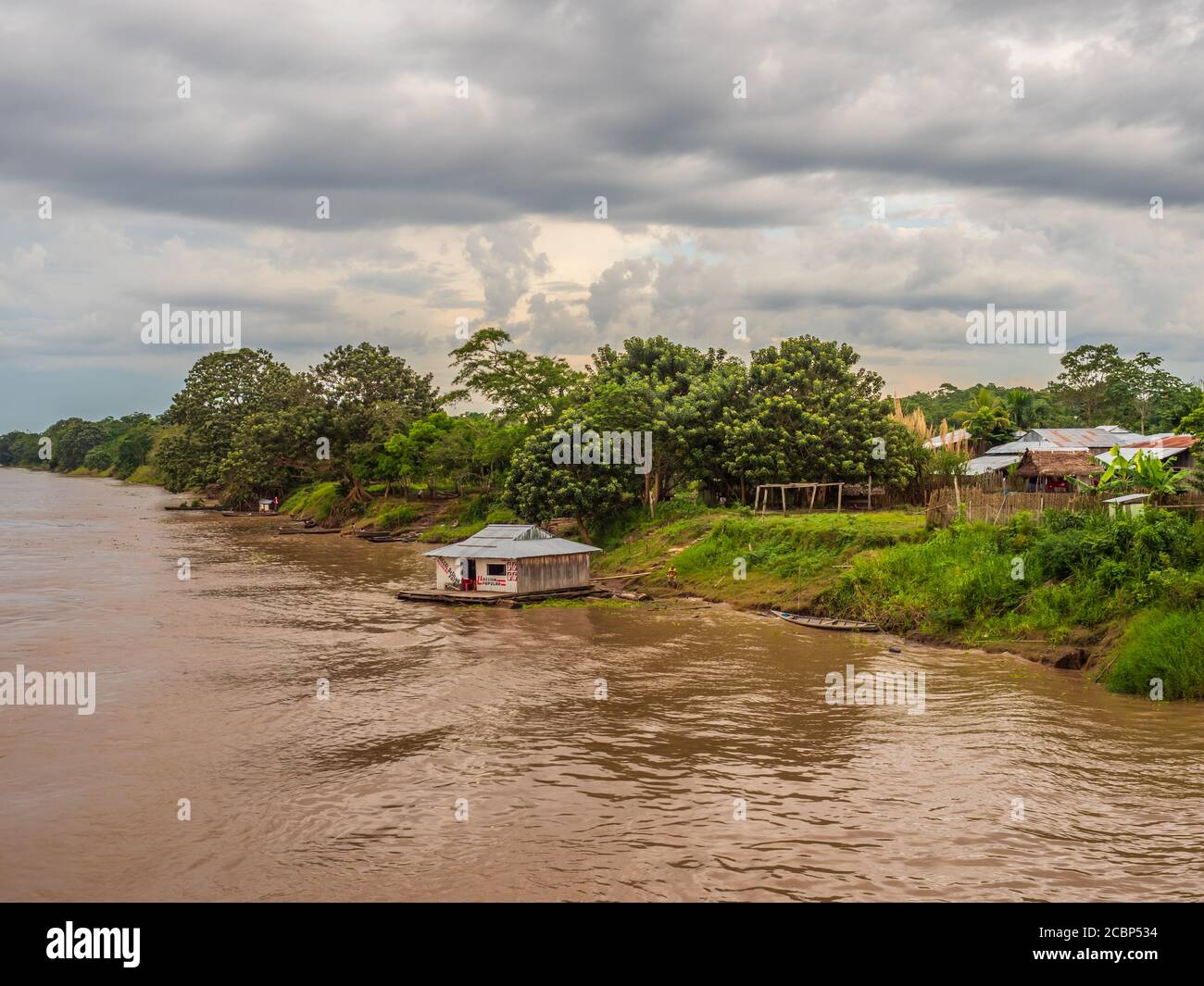 Amazon river, Peru - Mar 23, 2018: Small village on the bank of the ...