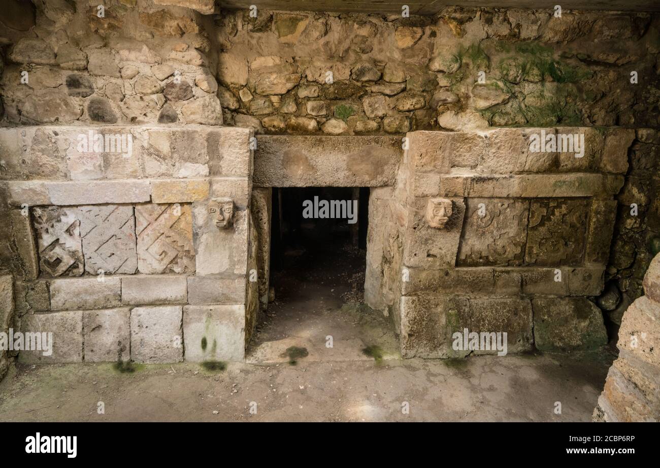 Carved stone heads and geometric designs flank the entrance to Tomb 30 ...