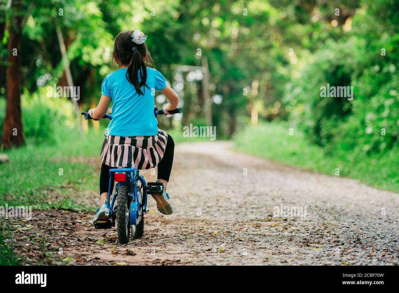 Back view girl riding bicycle hi-res stock photography and images - Alamy