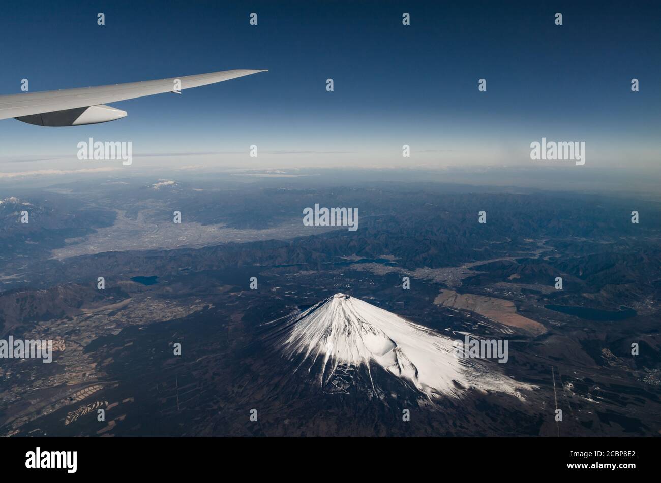 Aerial high angle top view of Mount Fuji, snow, sky and clouds. View ...