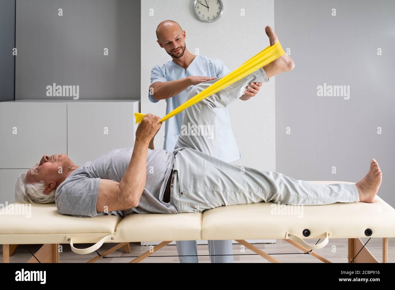 Knee Exercise Therapy And Treatment Using Physical Band Stock Photo - Alamy