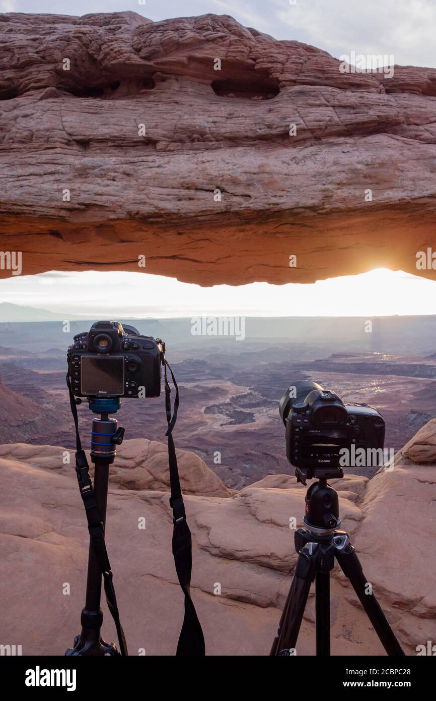 Cameras with view through Mesa Arch at sunrise, Colorado River Canyon ...