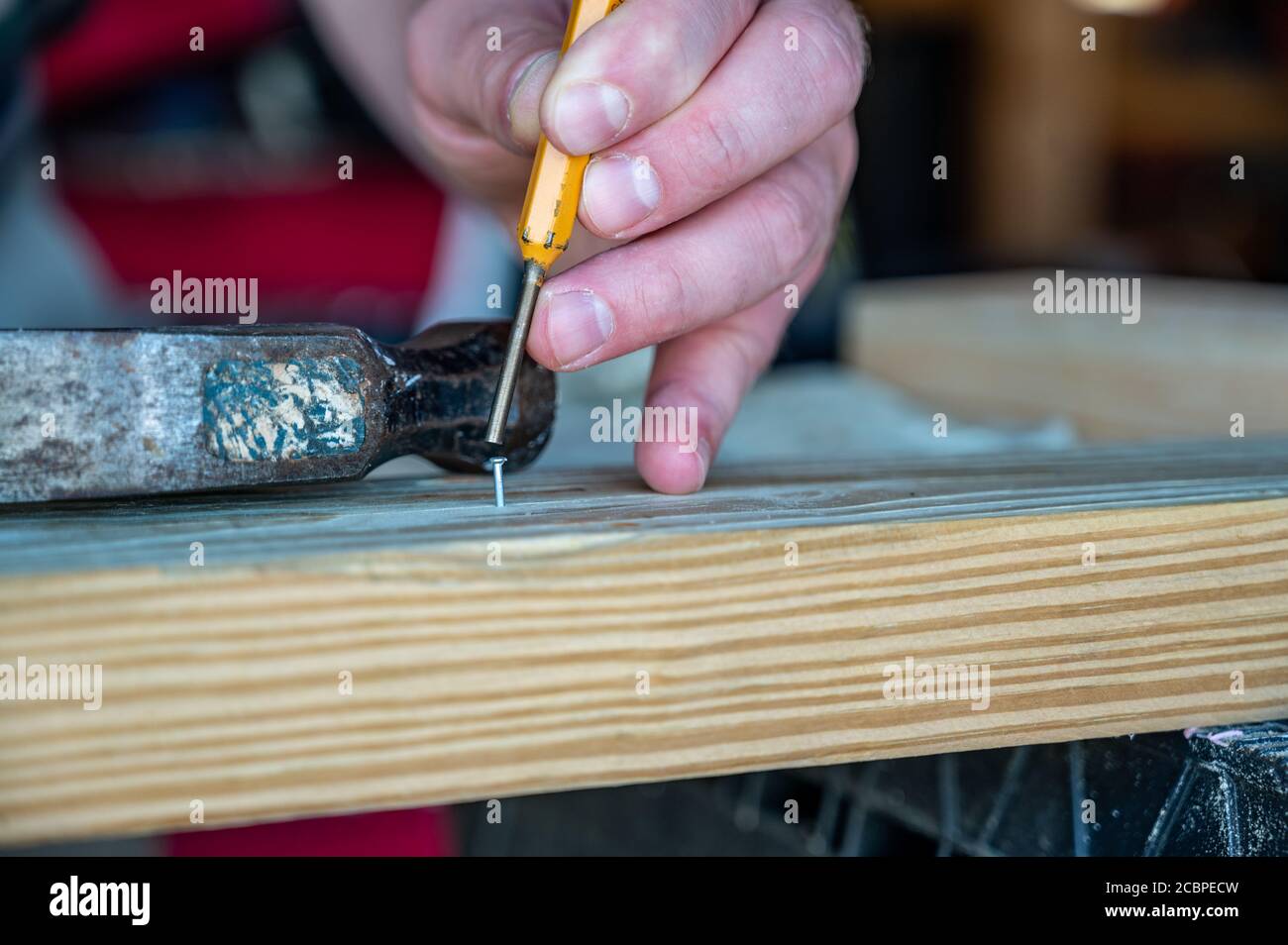 A nail set is a metal rod used to focus force from a hammer to the nail ...