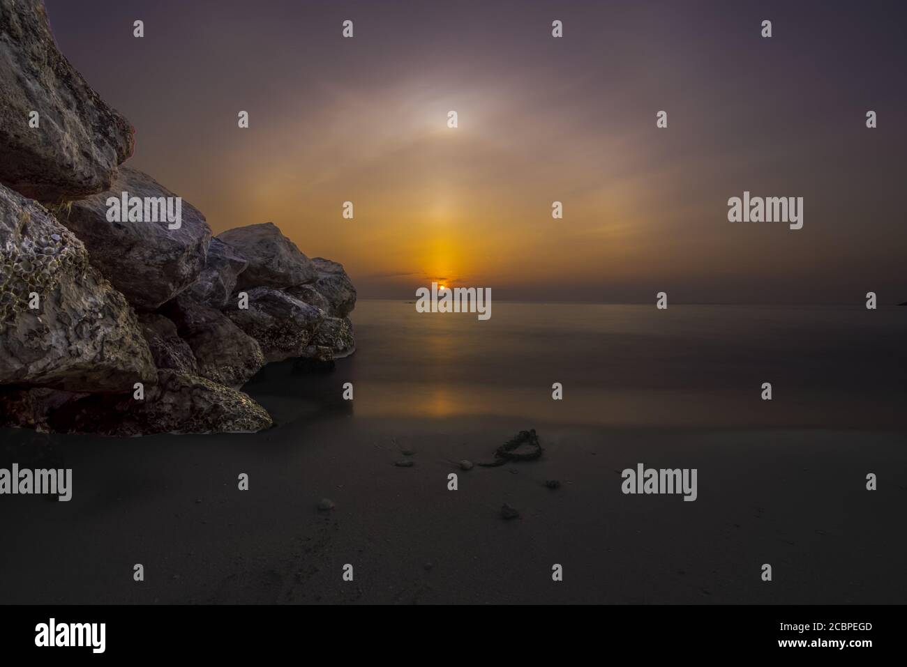 Mesmerizing view of the sun that is going to set and low tied sea waves ...