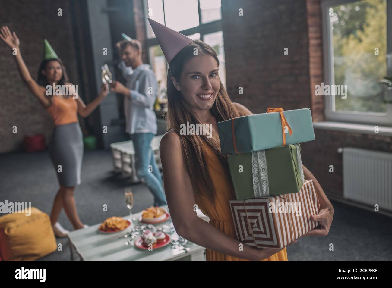 Woman getting presents during her birthday party Stock Photo - Alamy