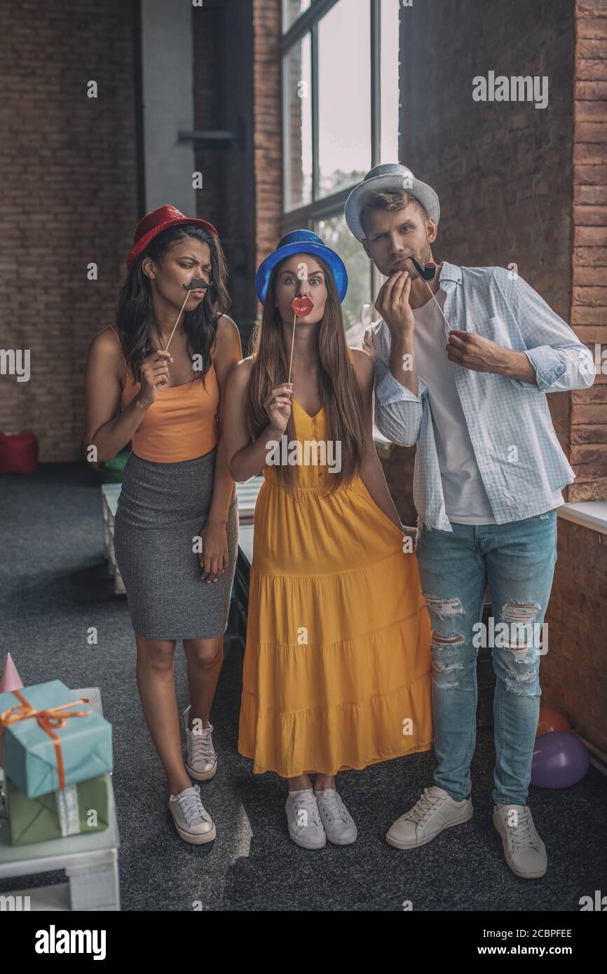 Friends having a masquerade during the party Stock Photo - Alamy