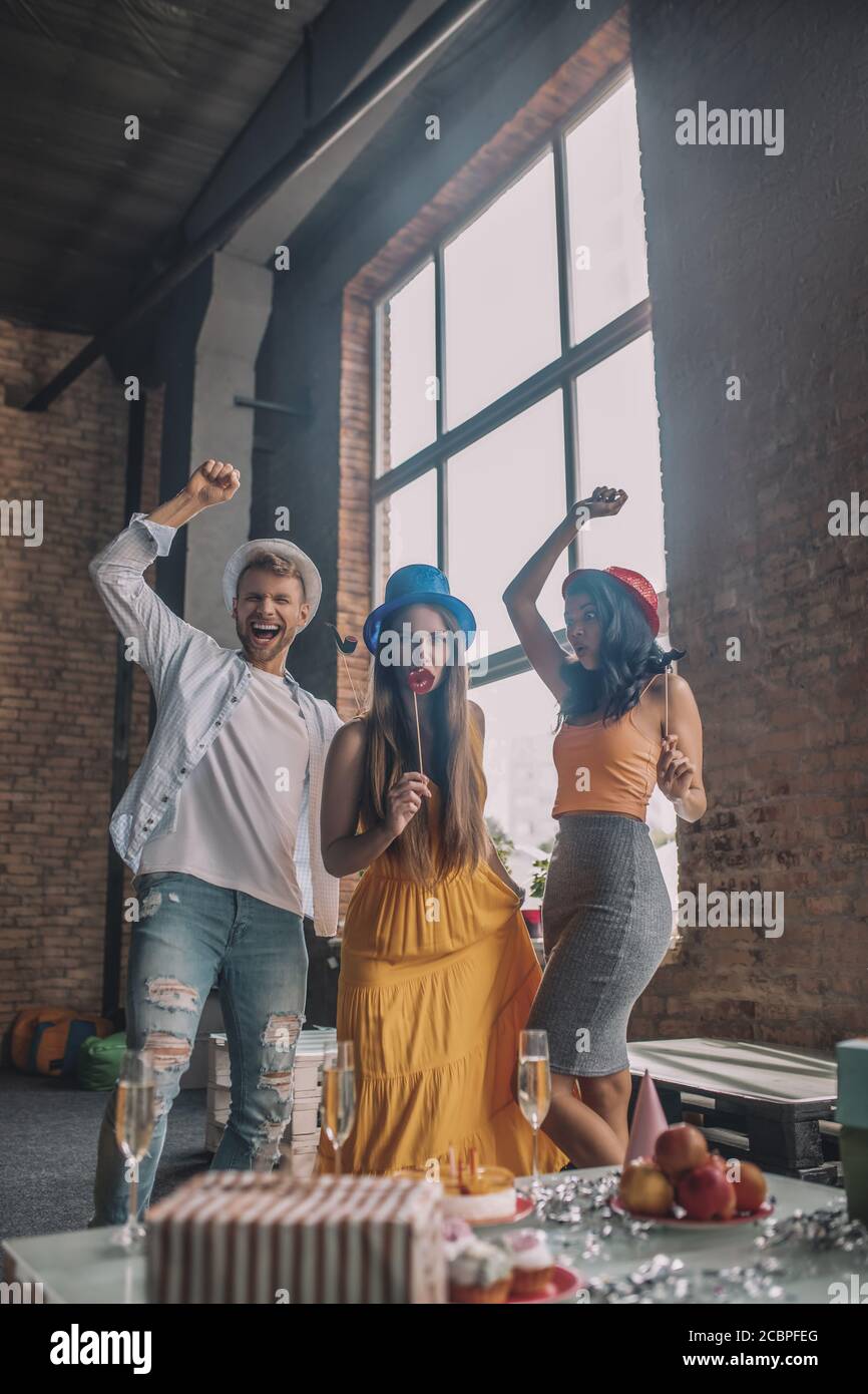 Three friends dancing at the birthday party Stock Photo - Alamy