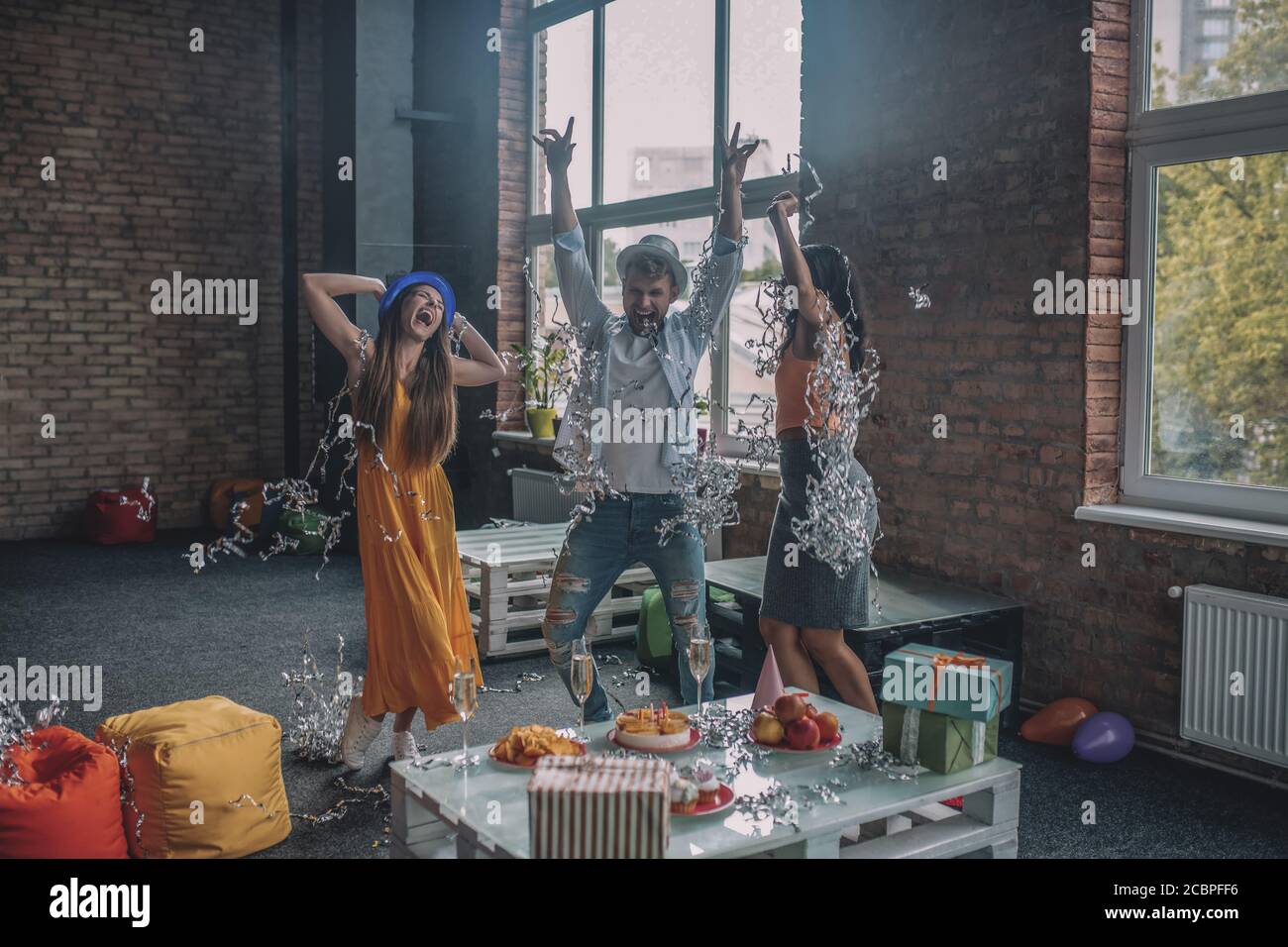 Three excited friends enjoying an amazing party Stock Photo - Alamy
