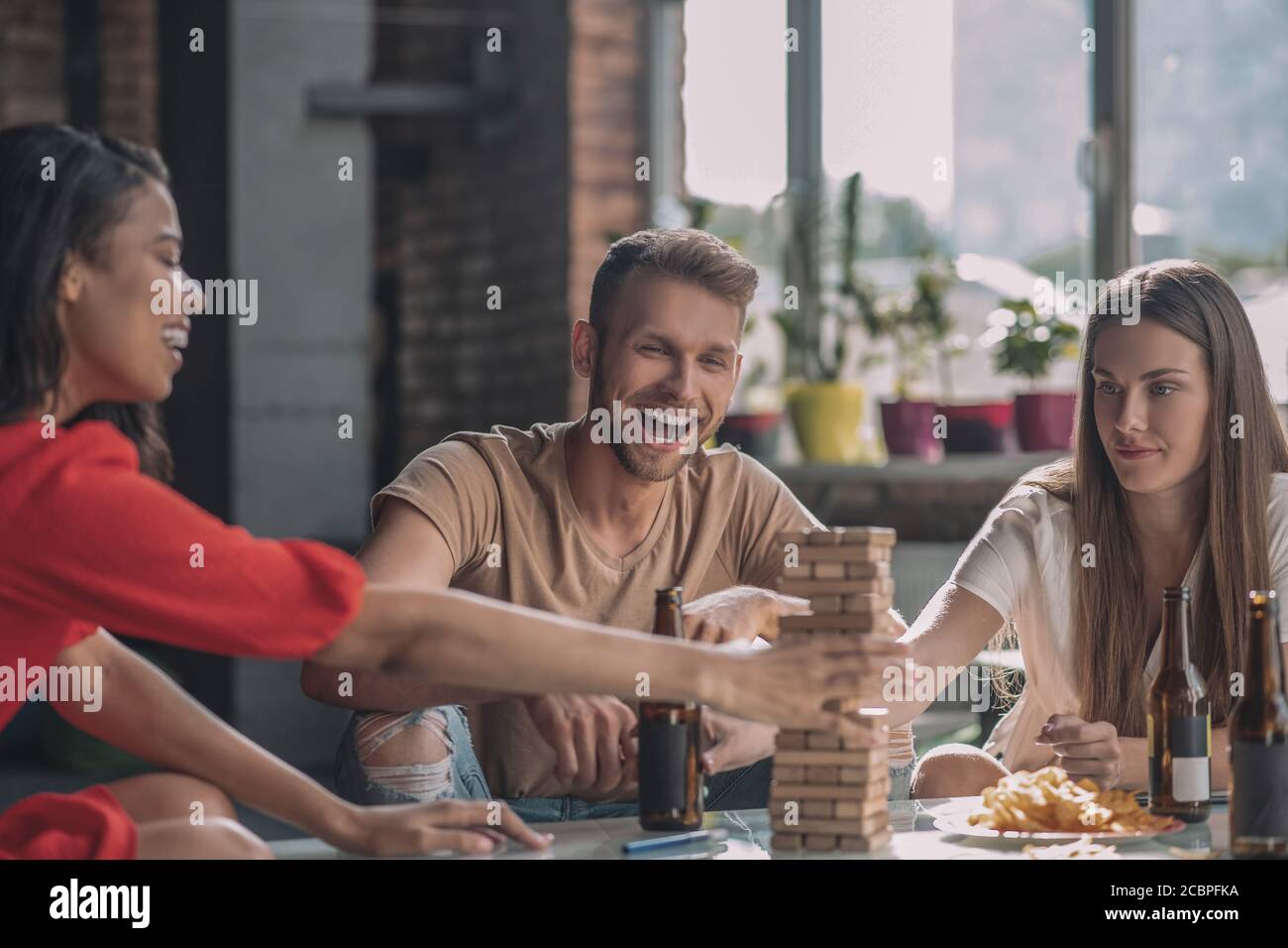 Friends having fun while playing Jenga at the party Stock Photo - Alamy