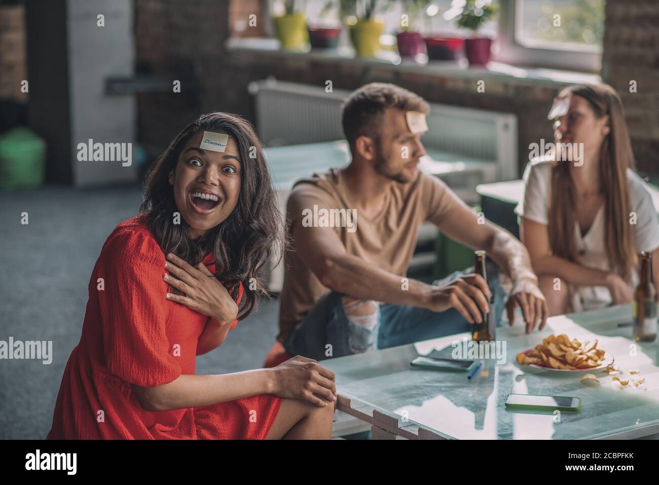 Friends playing Sticky head game at the party Stock Photo - Alamy
