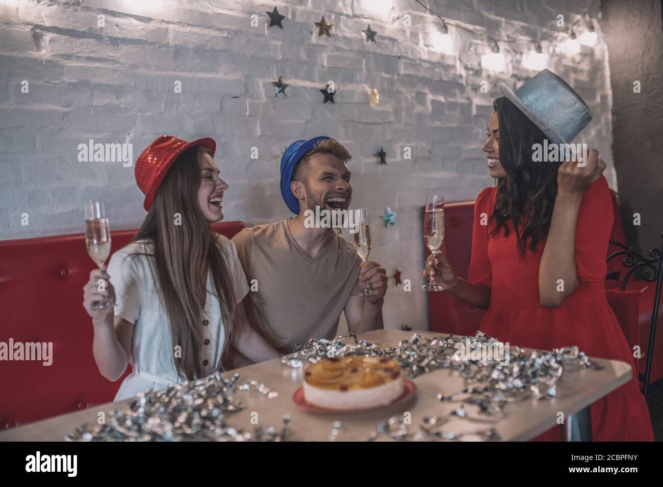Three friends having a party in the bar Stock Photo - Alamy