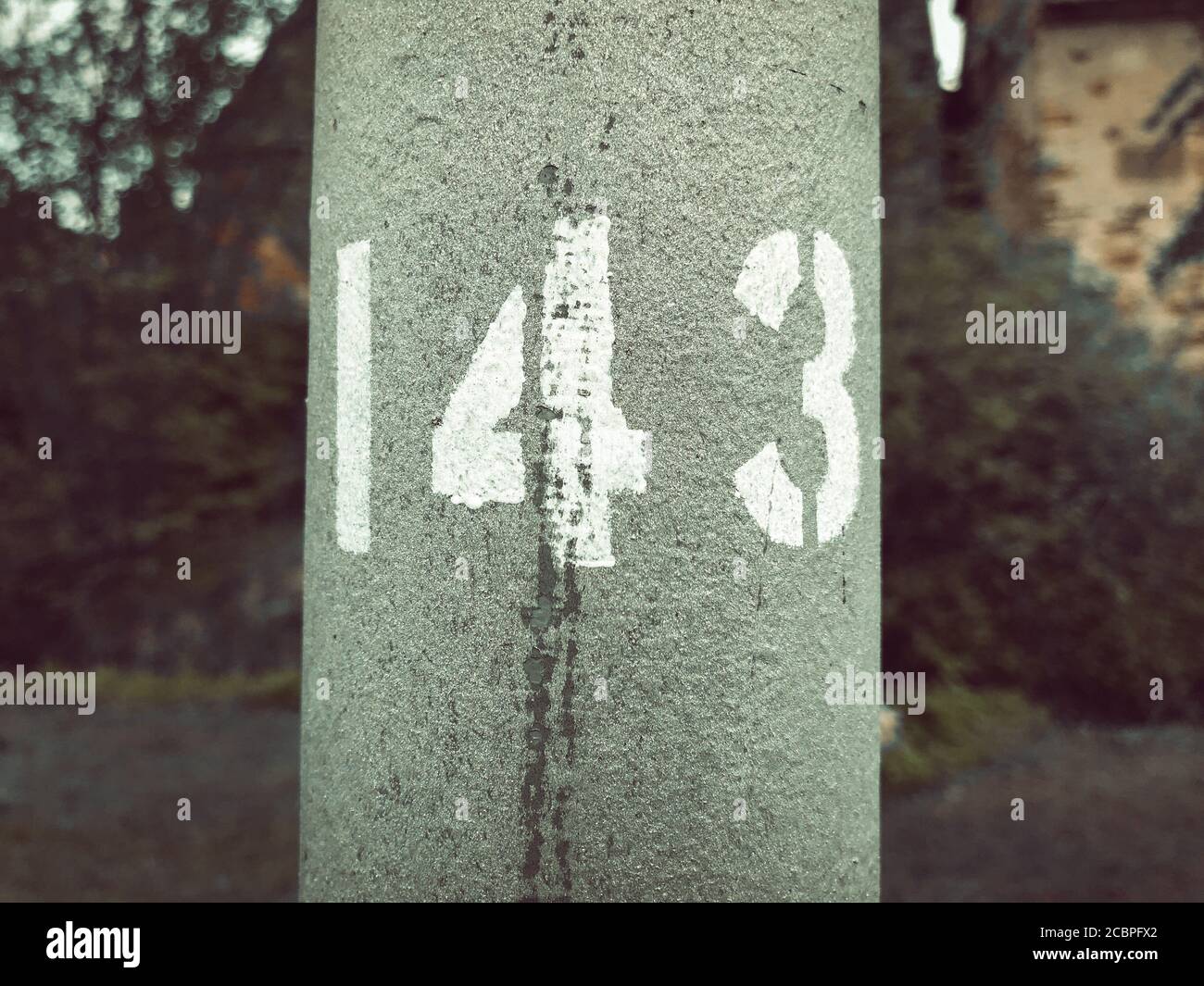 Concrete stone with "143" numbers on it Stock Photo - Alamy