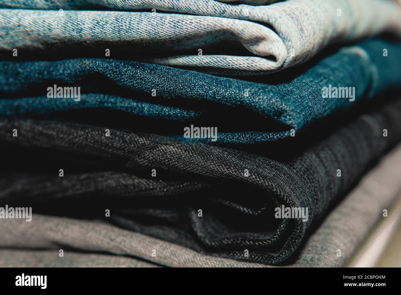 Stack of neatly folded jeans Stock Photo - Alamy