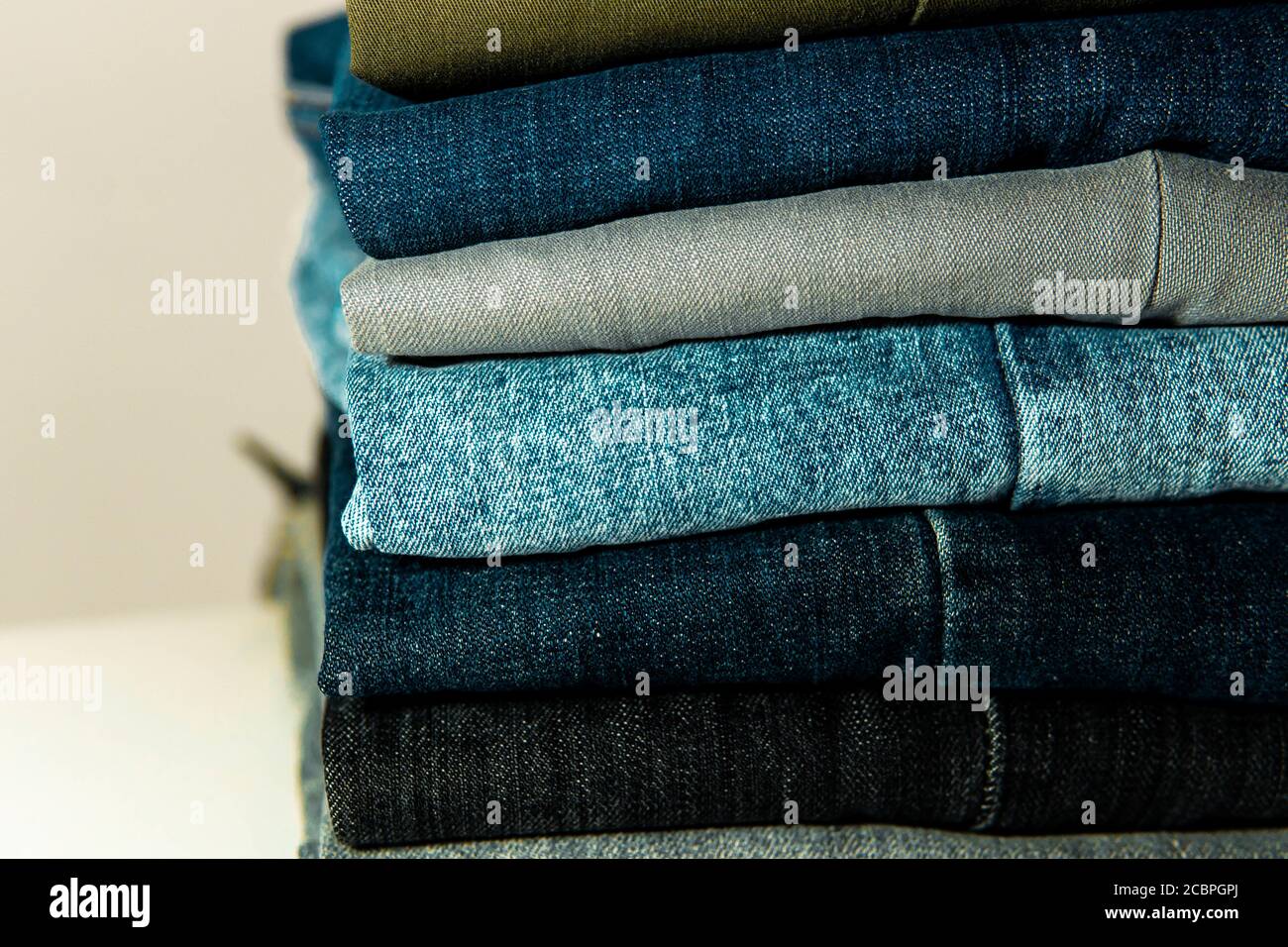 Stack of neatly folded jeans Stock Photo - Alamy