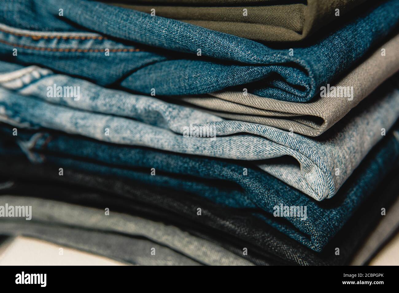 Stack of neatly folded jeans Stock Photo - Alamy