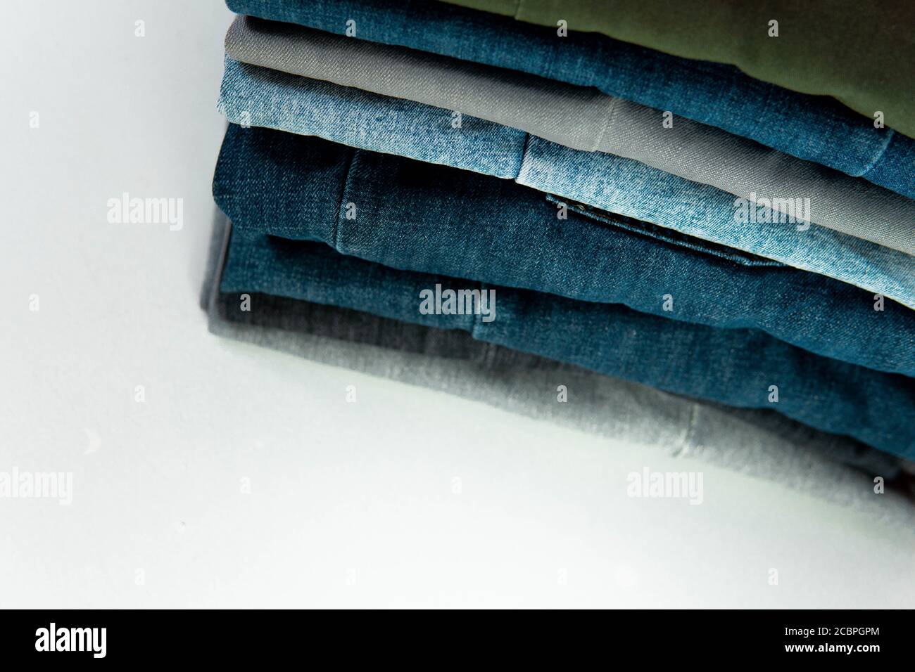 Stack of neatly folded jeans on white background Stock Photo - Alamy