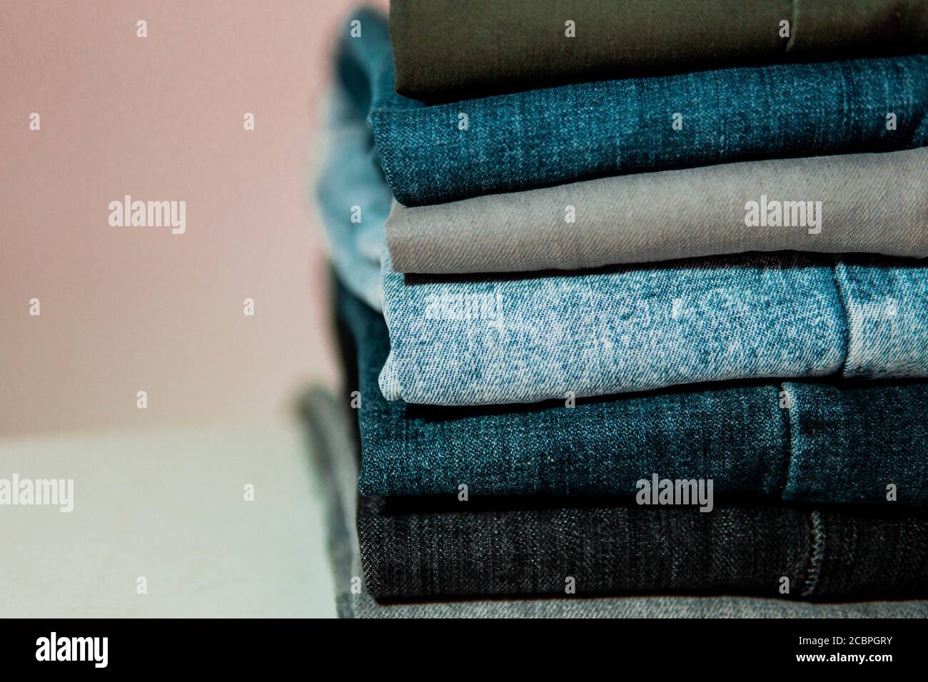Stack of neatly folded jeans Stock Photo - Alamy
