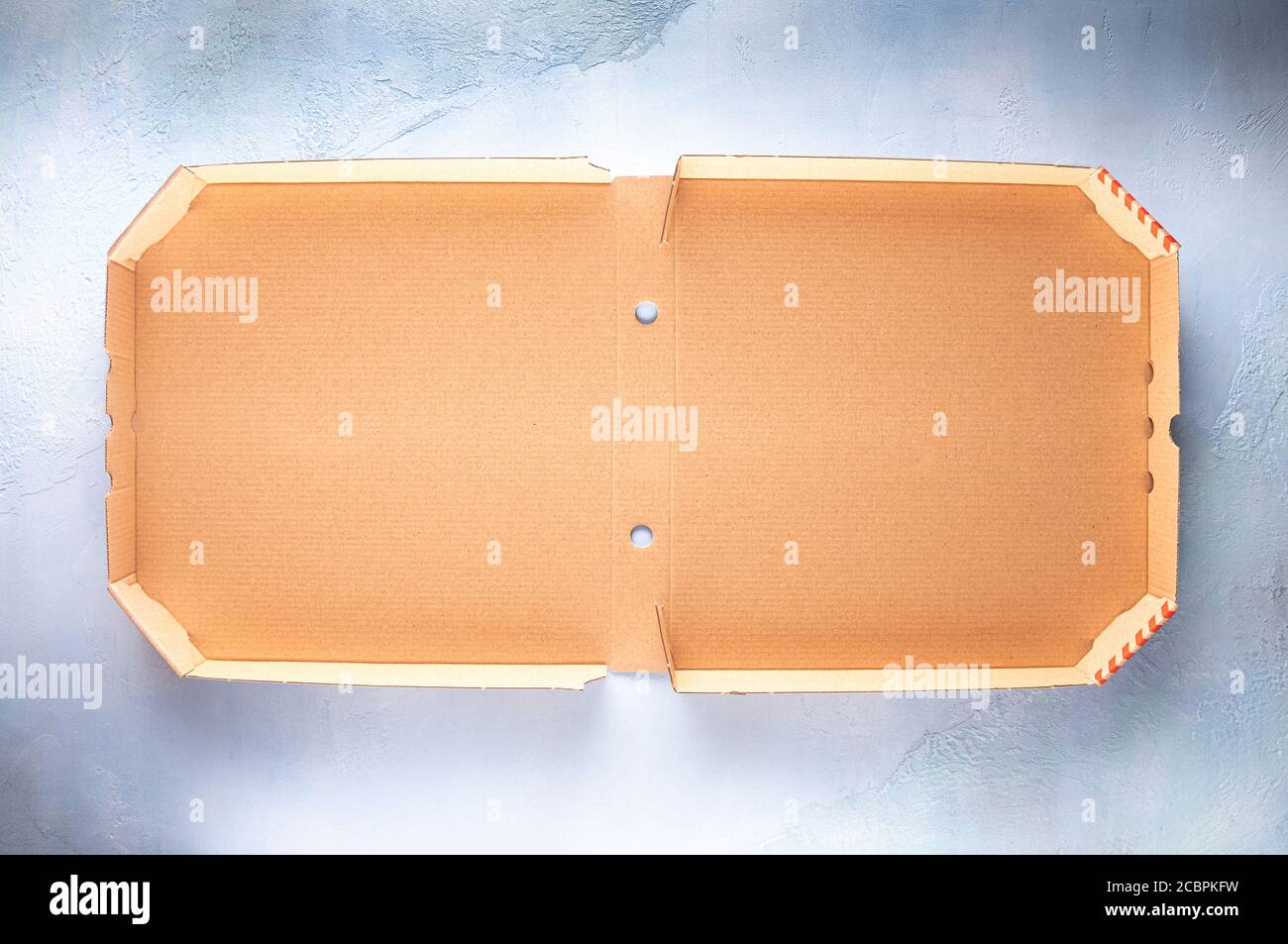 Whole new clean brown opened empty pizza box made of paperboard on blue ...