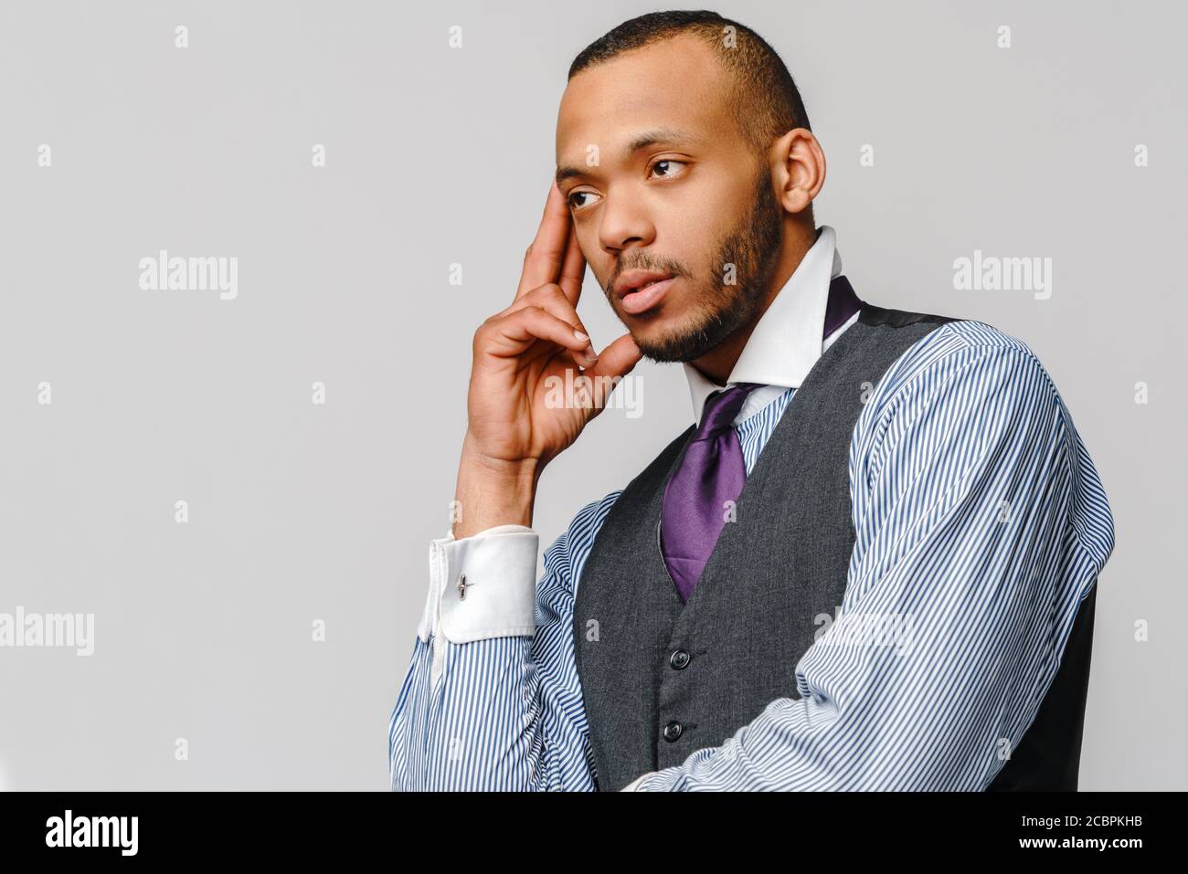 African-American businessmanman making hard decision over grey ...